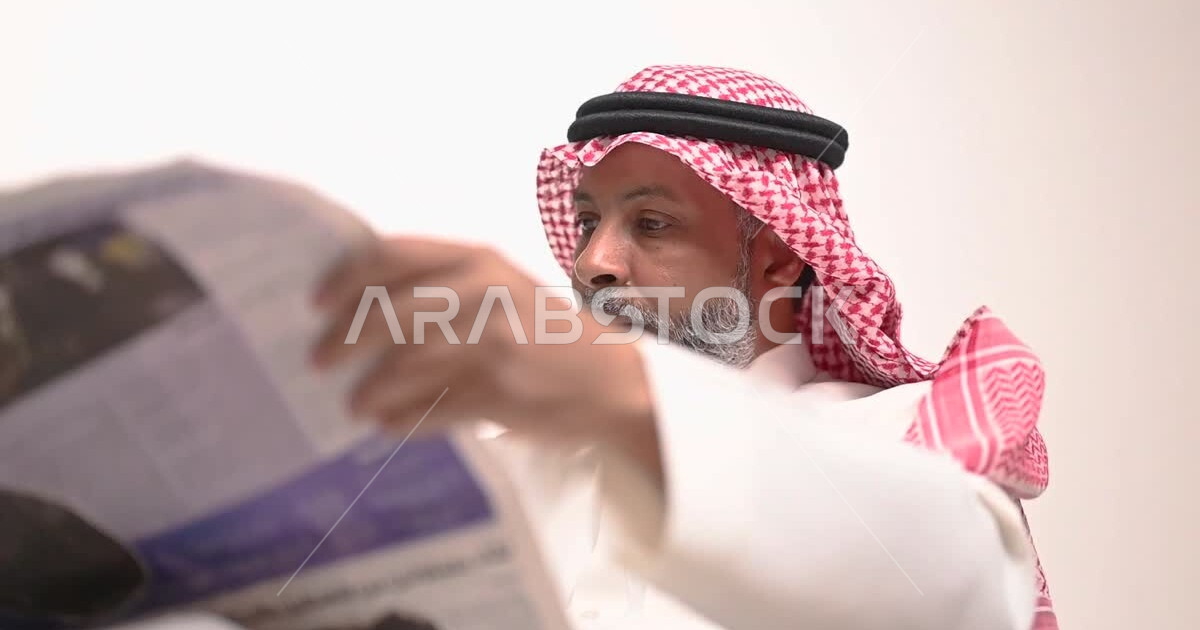 An elderly Arab Gulf Saudi man wearing traditional Saudi dress and ...