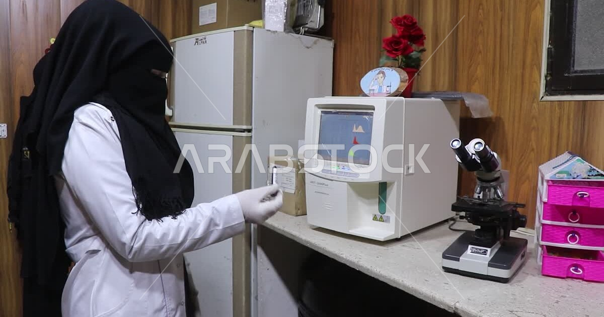 Close-up of a veiled Saudi Arabian Gulf woman wearing a medical coat in ...