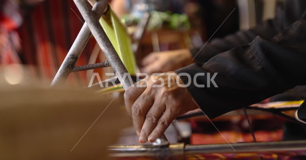 Spinning and knitting textiles and cloth, a close-up of a Saudi Arabian ...