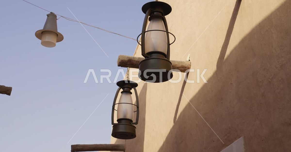 Close-up of a copper lamp hanging on the walls of houses in Diriyah ...