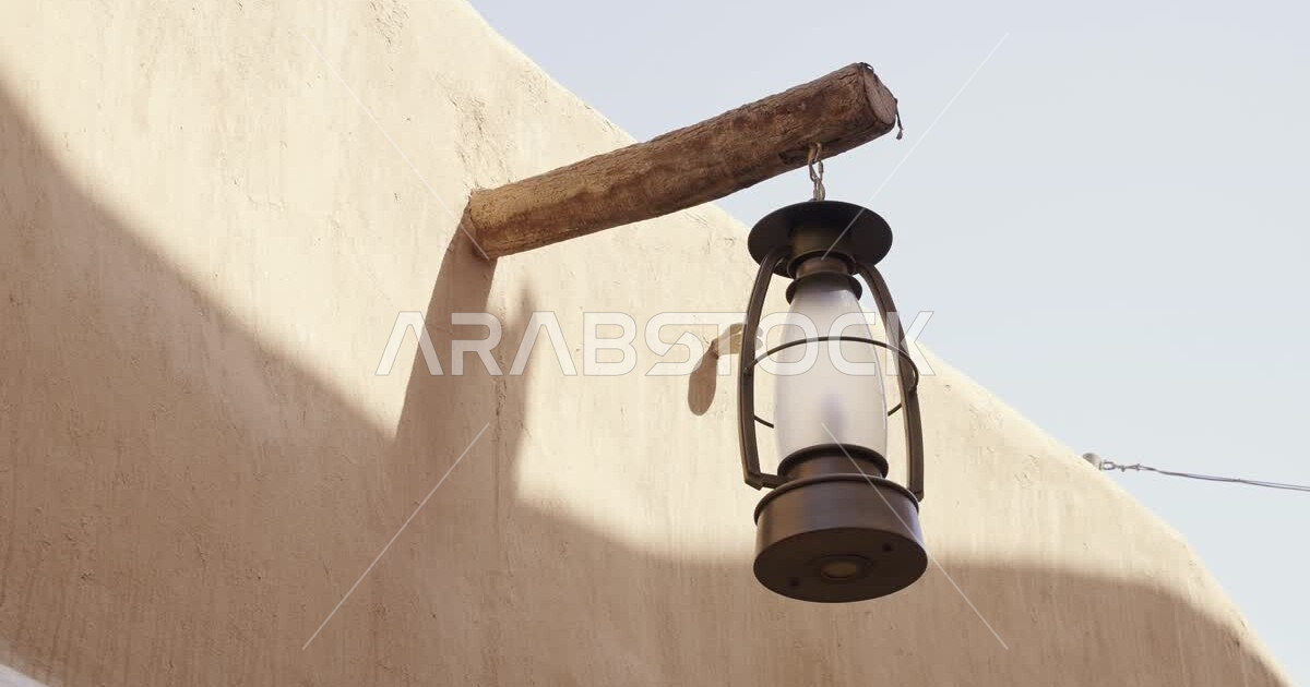 Close-up of a copper lamp hanging on the walls of houses in Diriyah ...