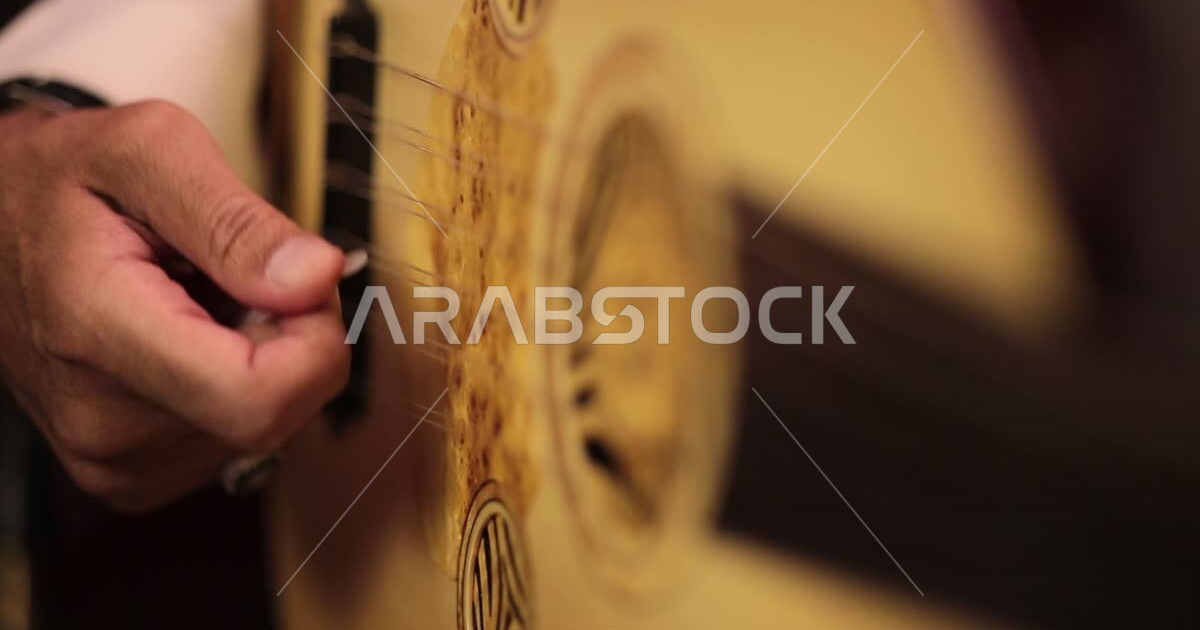 Close-up of the hand of a Saudi Arabian Gulf musician playing the Oud ...