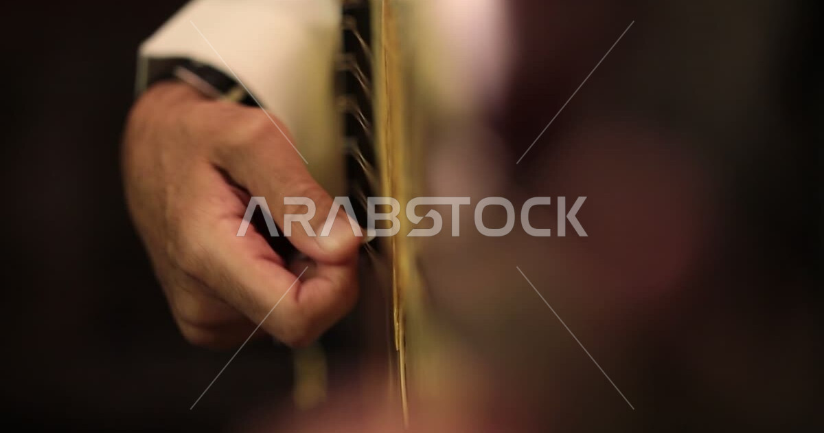 Side view of the hand of a Saudi Arabian Gulf musician wearing ...