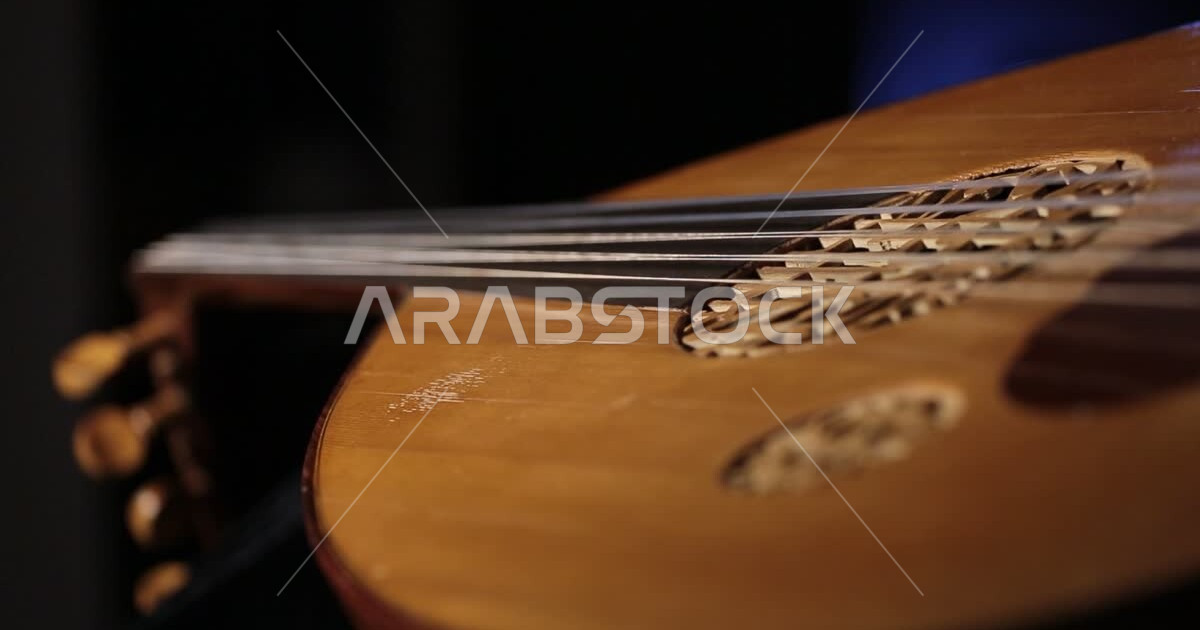 Practicing Saudi folk arts, a very close-up of the oud instrument ...