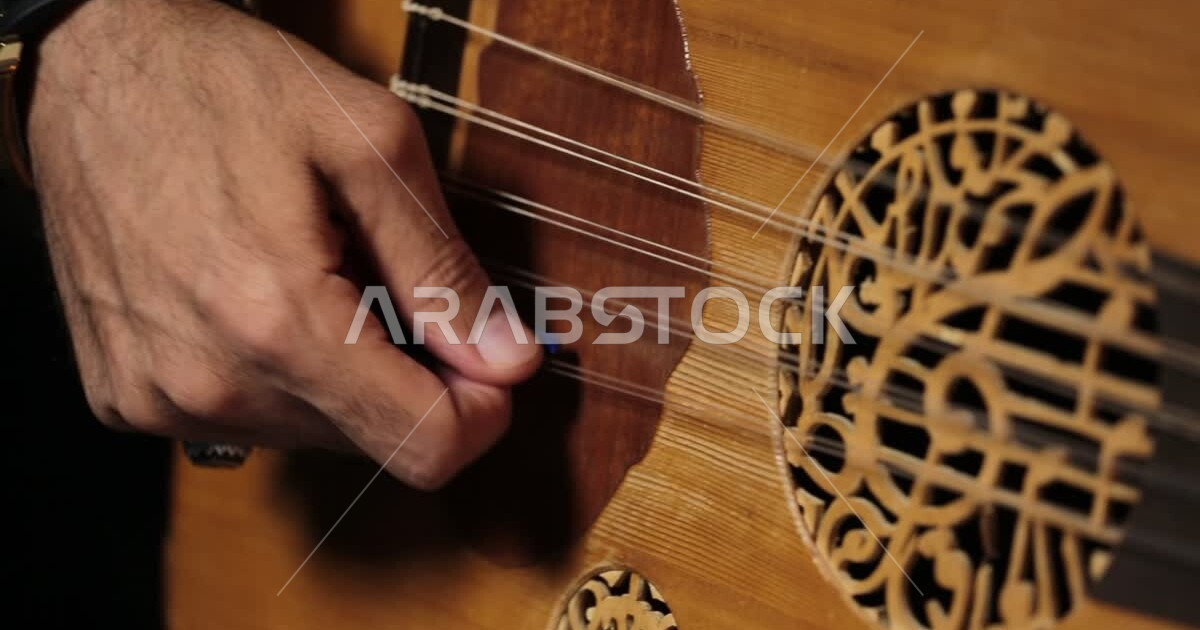 Playing on popular traditional instruments, close-up of a Saudi Arab ...