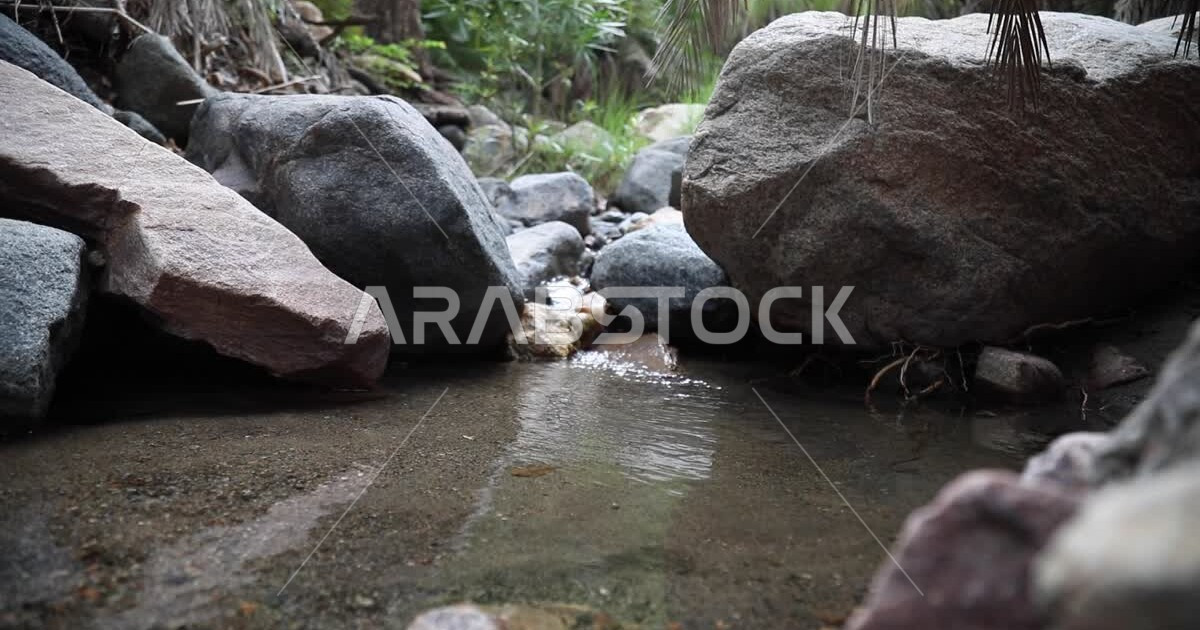 Water flowing between rocks, flowing water stream, pure water stream ...