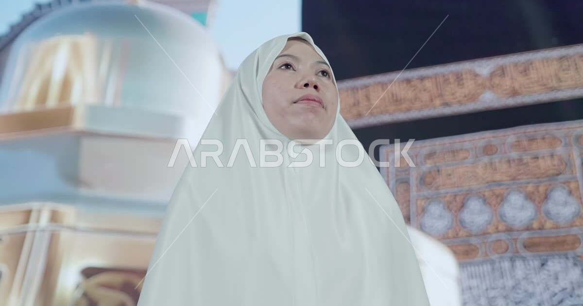 Performing the rituals of Hajj and Umrah, an Asian Muslim woman wearing ...