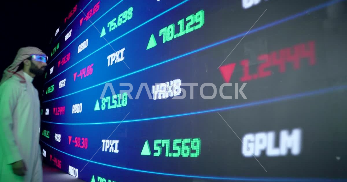 Monitoring the stock market through modern electronic screens, standing ...