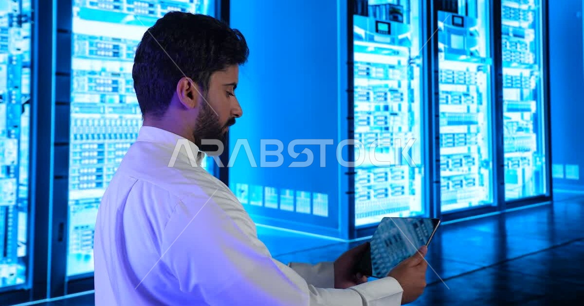 Servers barn, side view of a young Arab Gulf Saudi who uses a modern ...