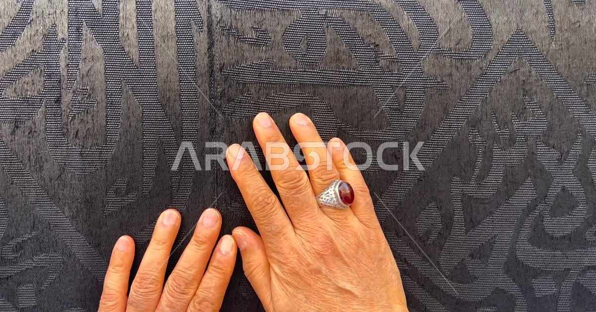 Performing the rituals of Hajj and Umrah, close-up of the hand of an ...