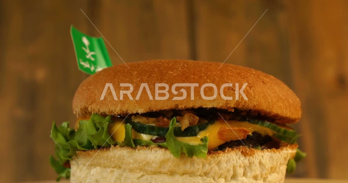 Delicious burger sandwich with layers of fresh meat and lettuce with ...