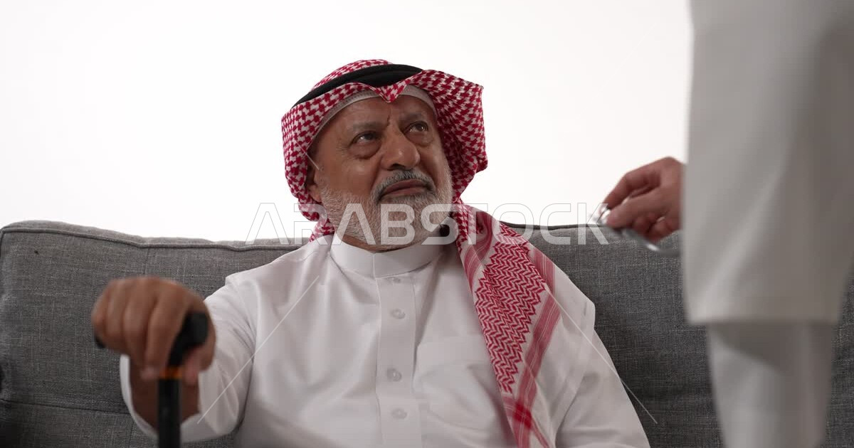 Using a stethoscope for a medical examination, a Saudi Arab doctor ...