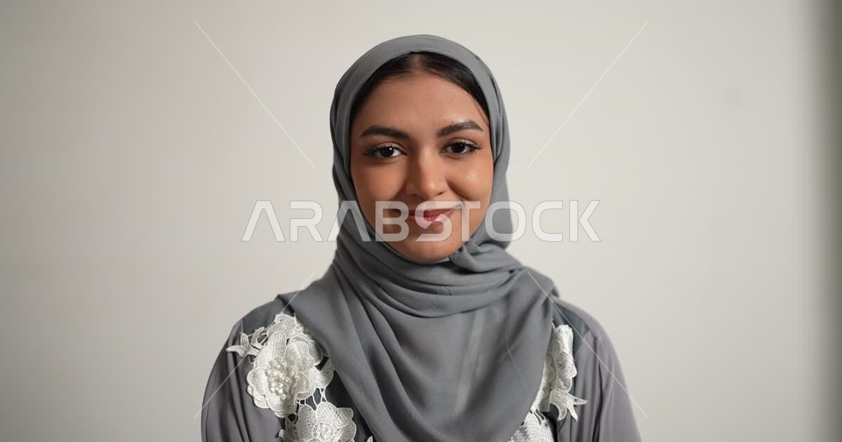 Portrait of a smiling Saudi Arabian Gulf woman, wearing the Saudi abaya ...
