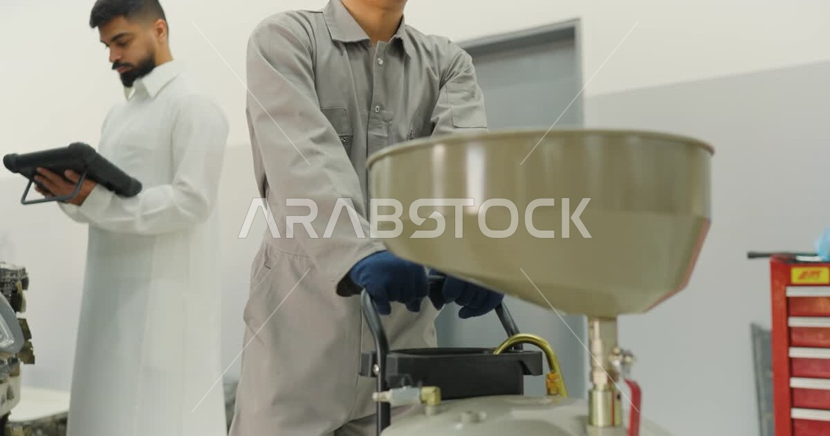 A mechanical engineer in a car inspection center using a tablet ...