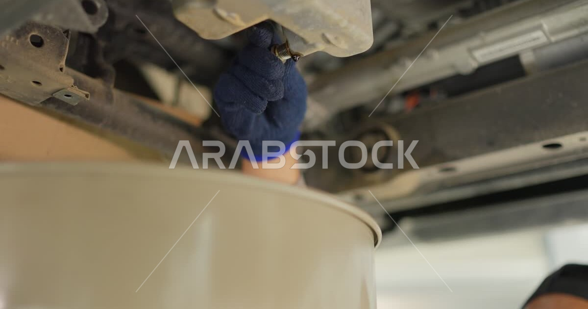 A mechanical engineer in a car inspection center doing periodic ...