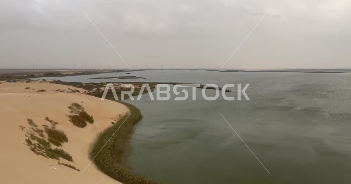Yellow Lake in Al-Ahsa in the Kingdom of Saudi Arabia, soft sand dunes ...