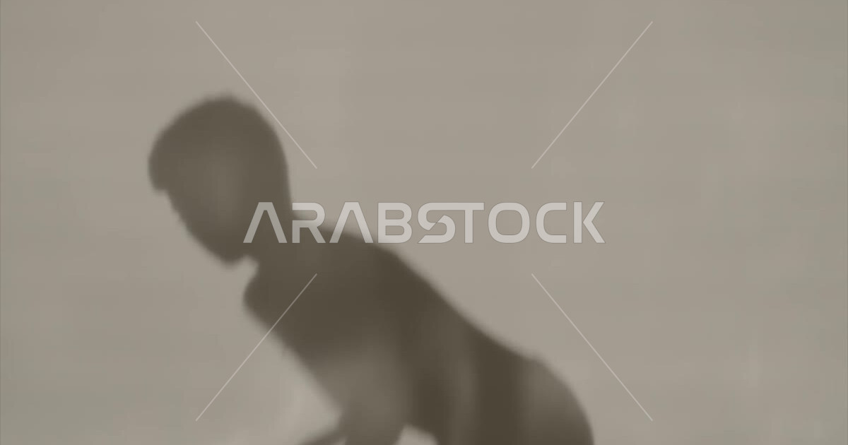 Fitness and physical agility, a close-up of a girl's shadow performing ...