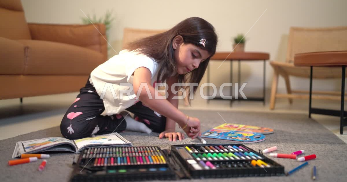 Creativity, learning and skills development, drawing coloring game, a Saudi Arabian Gulf girl ...