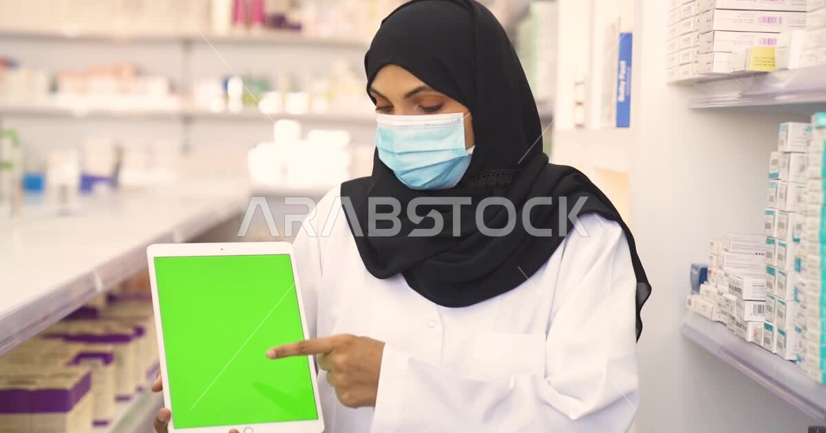 A Saudi Arabian Gulf pharmacist wearing a mask to prevent corona virus ...