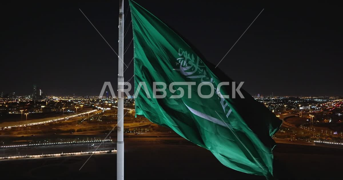 Saudi Flag Day, close-up of the Saudi flag pole in Diriyah, car traffic ...