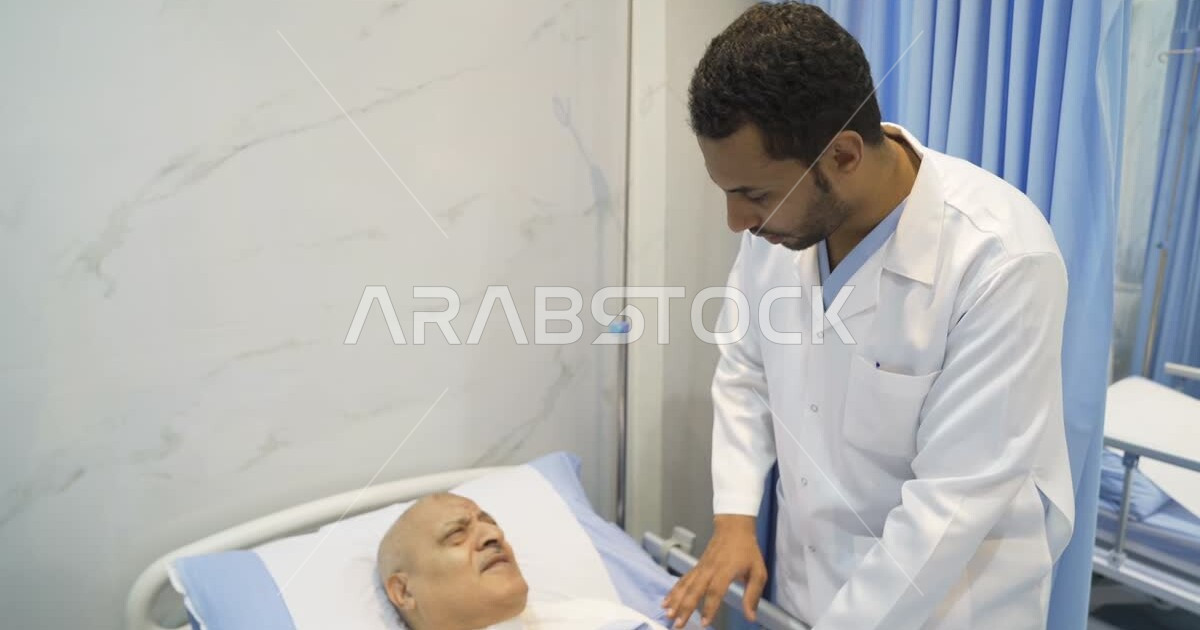 An old man, Arab, Gulf, Saudi, patient lying on a hospital bed ...