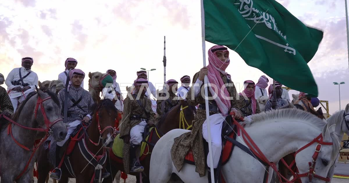 Carrying the Saudi flag, guns and weapons, a group of Saudi Gulf Arab ...
