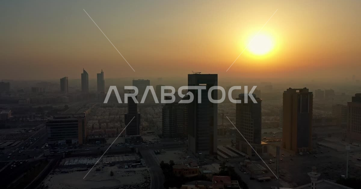 View of the sun disk at sunset, drone photography of buildings, towers ...