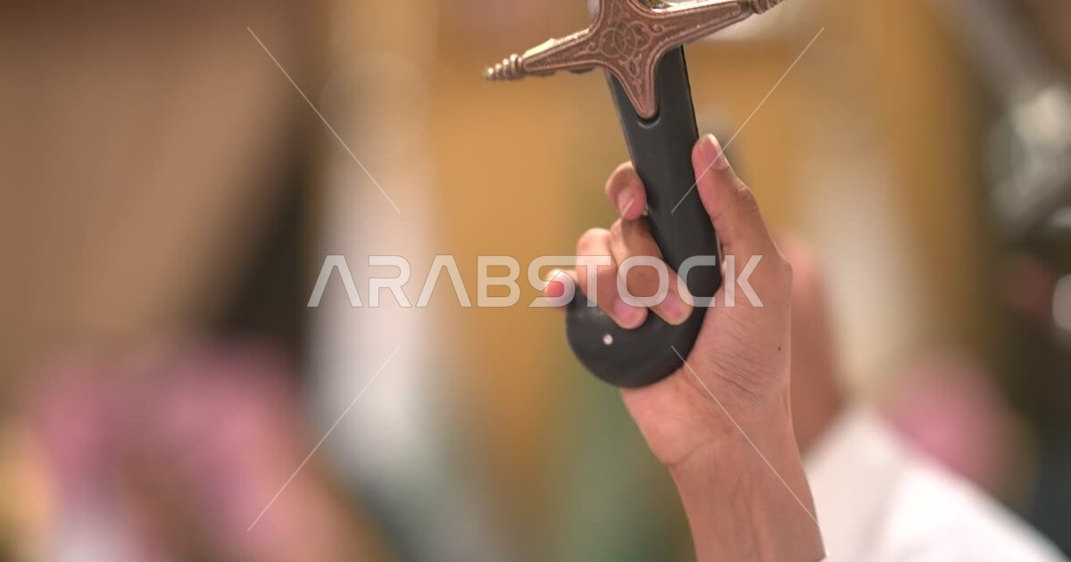 Close-up depiction of a Saudi Arab Gulf man holding a sword, folk ...
