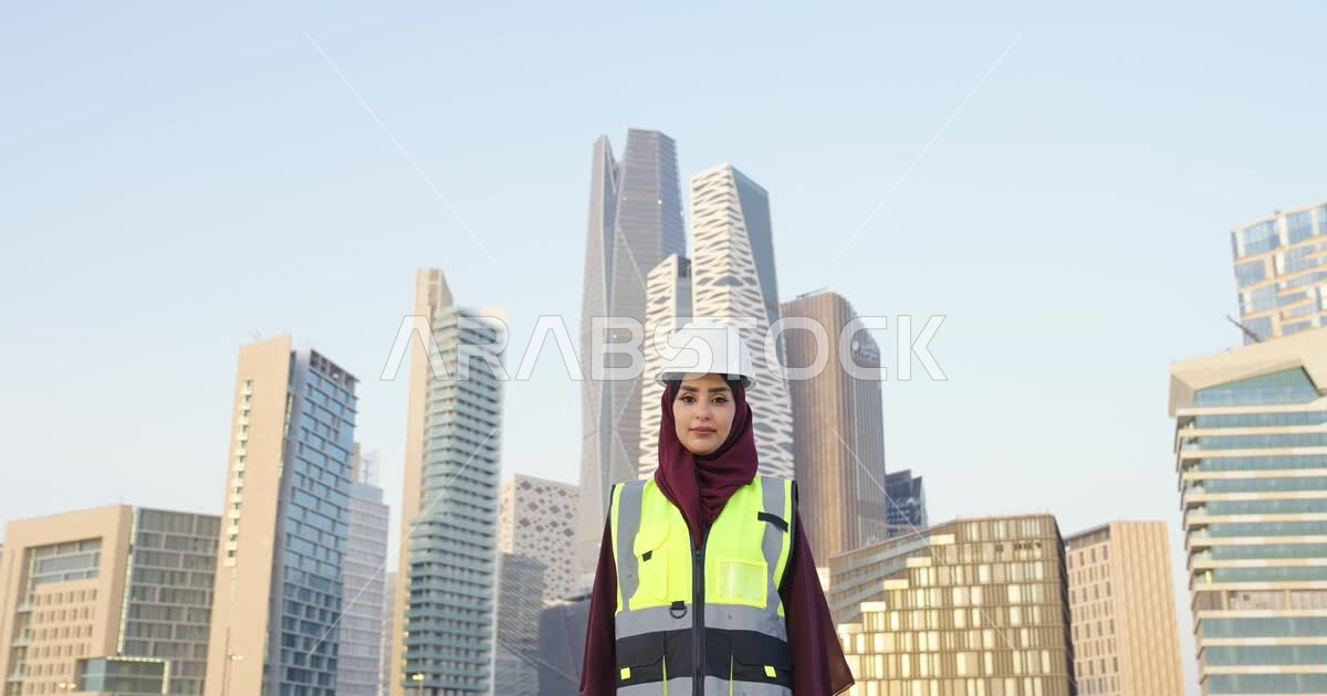 A veiled Saudi Gulf Arab engineer wearing a helmet and protection vest ...