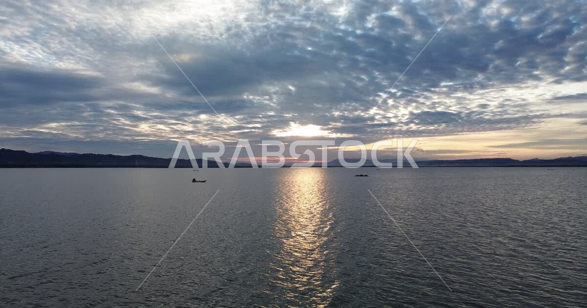 Reflection of sunlight on sea water, drone photography of a small ...