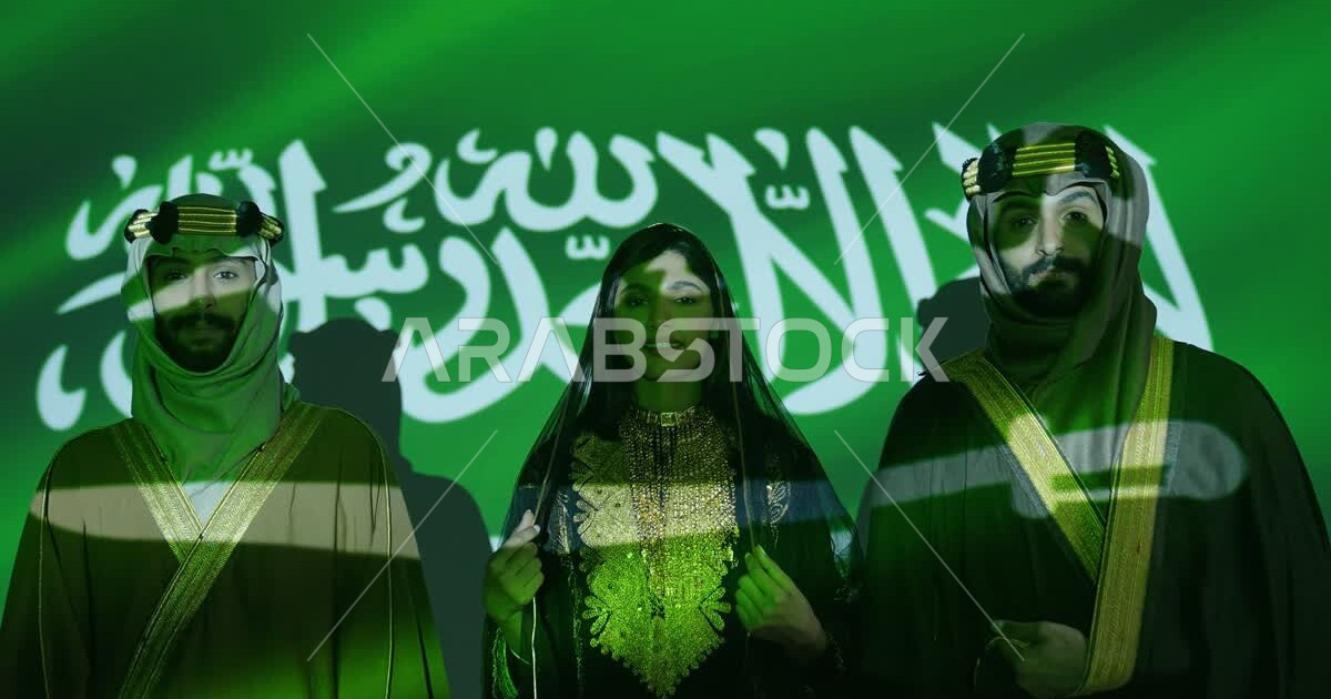 The fusion of the light of the flag on two men and women, Saudi Arabs ...