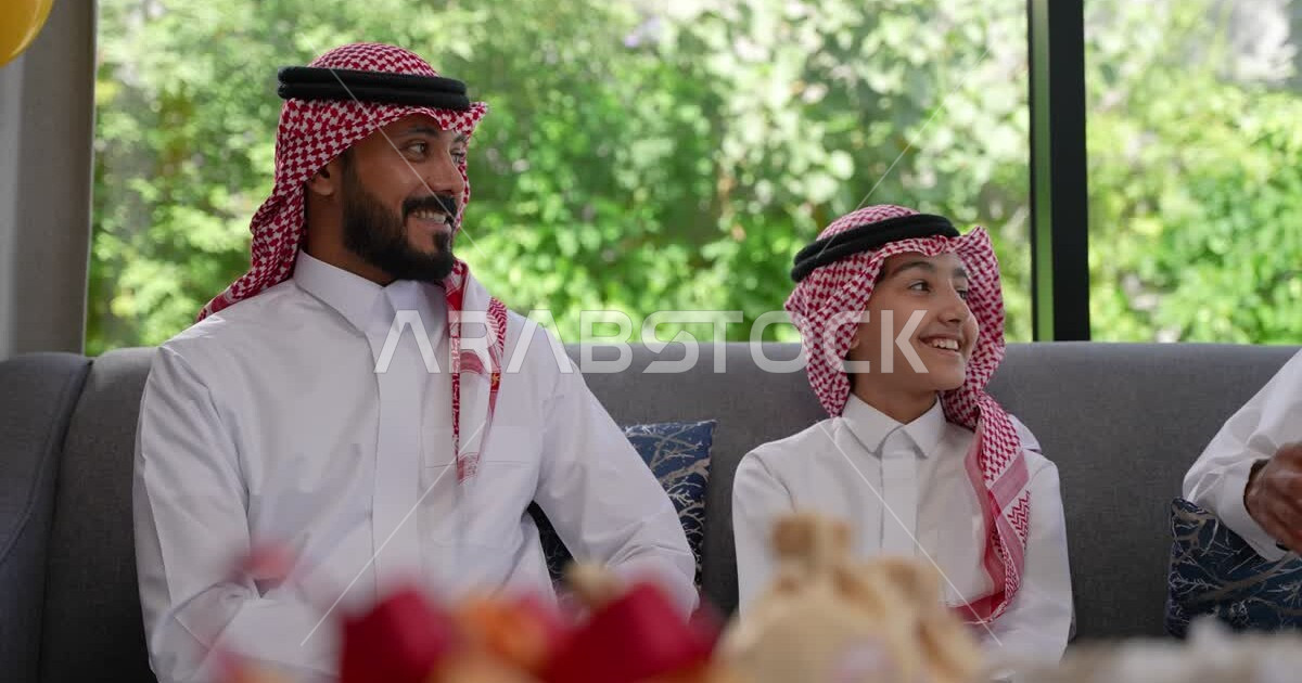 Hanging out and laughing with family members, a Saudi Gulf Arab man ...