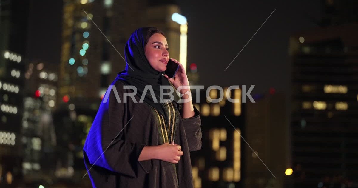 Answering and responding to calls via mobile phone, a veiled Saudi Gulf ...