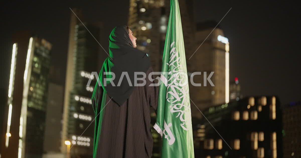 Saudi Flag Day, March 11, a photograph from behind of a veiled Saudi ...