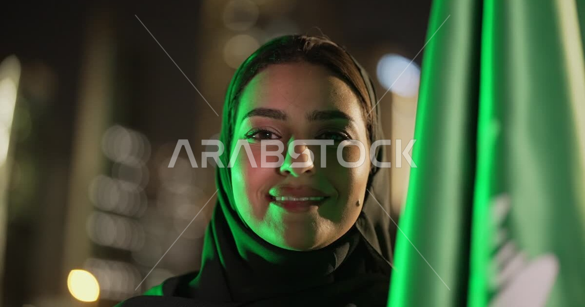 Saudi Flag Day March 11th, close-up of a veiled Saudi Gulf Arab woman ...