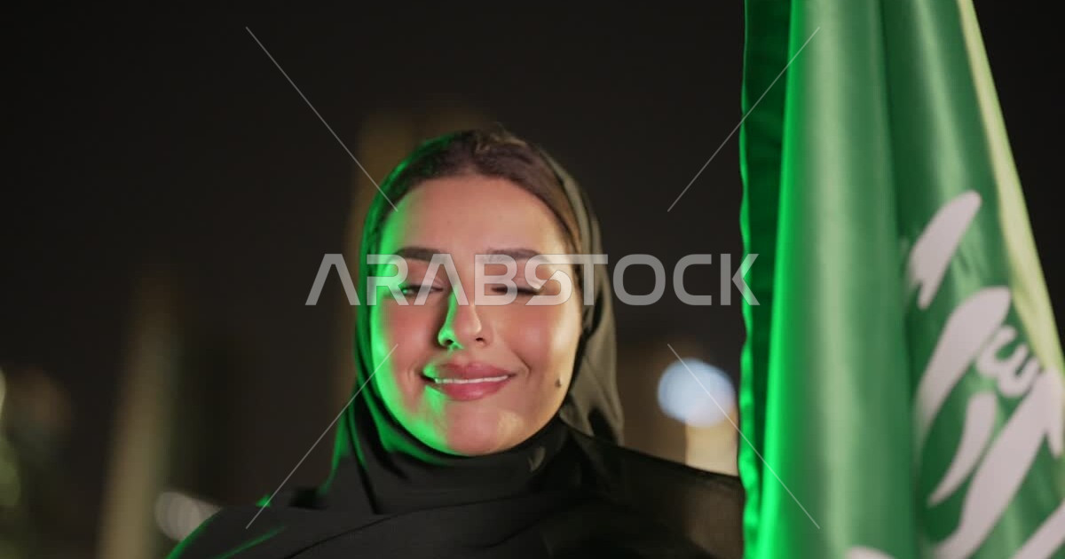 Saudi Flag Day, March 11, a close-up of a veiled Saudi Gulf Arab woman ...