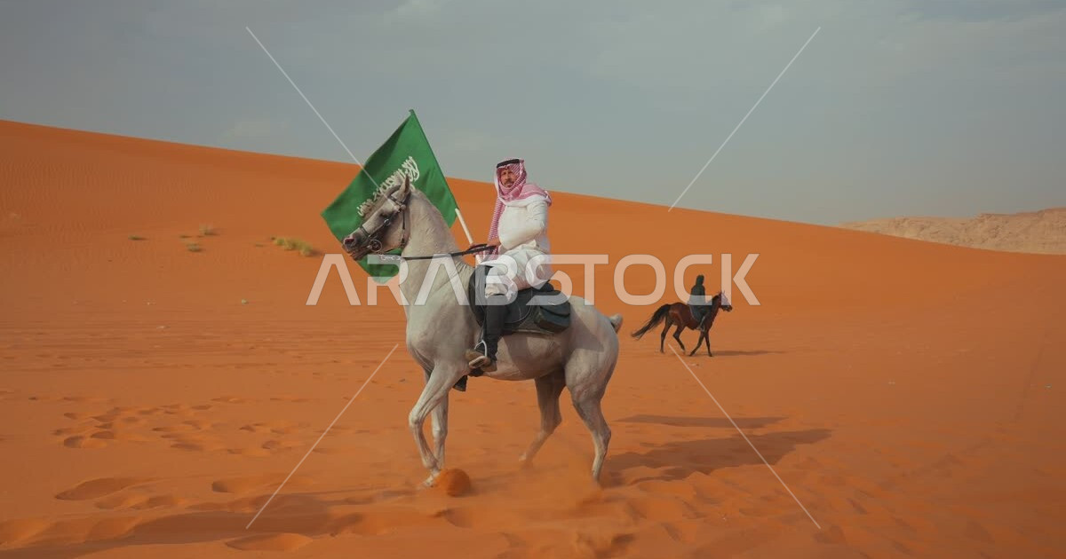 Raising the Saudi flag in the desert areas to celebrate the anniversary ...