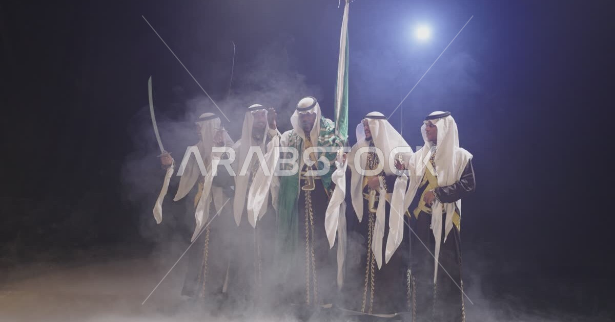 Folk songs and dancing with swords in the Hijazi Ardha, wearing the ...