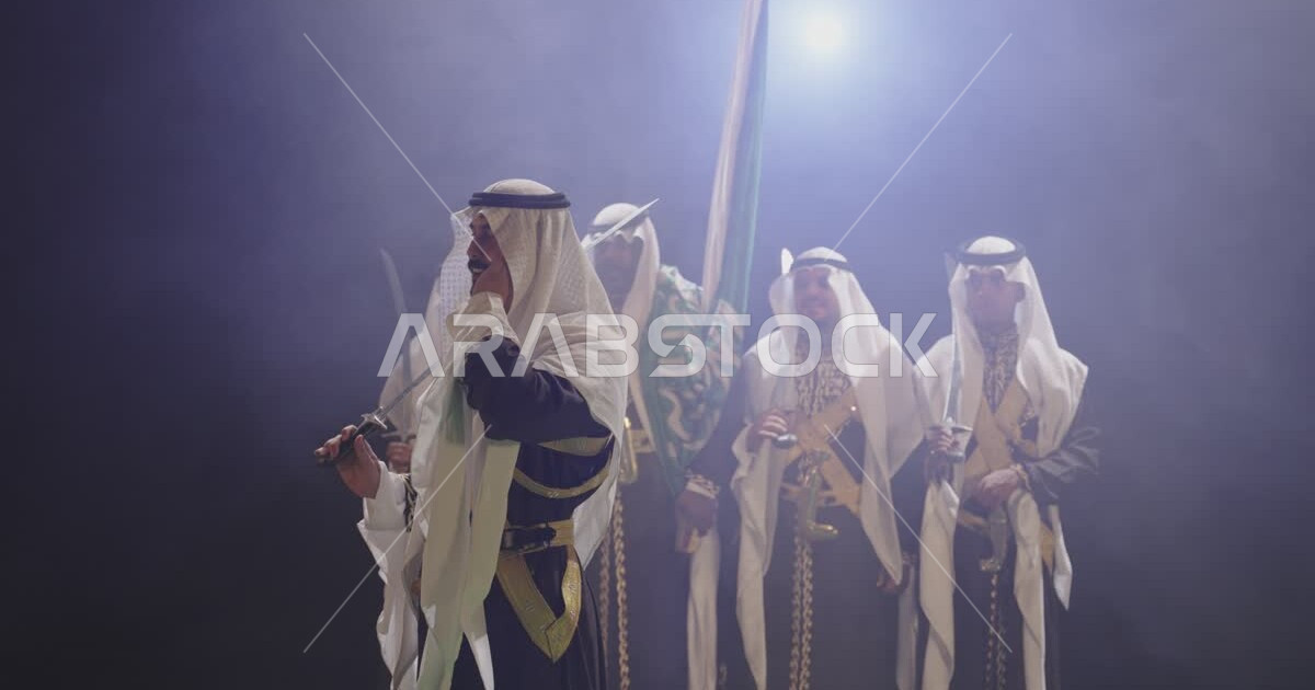 Folk songs and dancing with swords in the Hijazi Ardha, wearing the ...