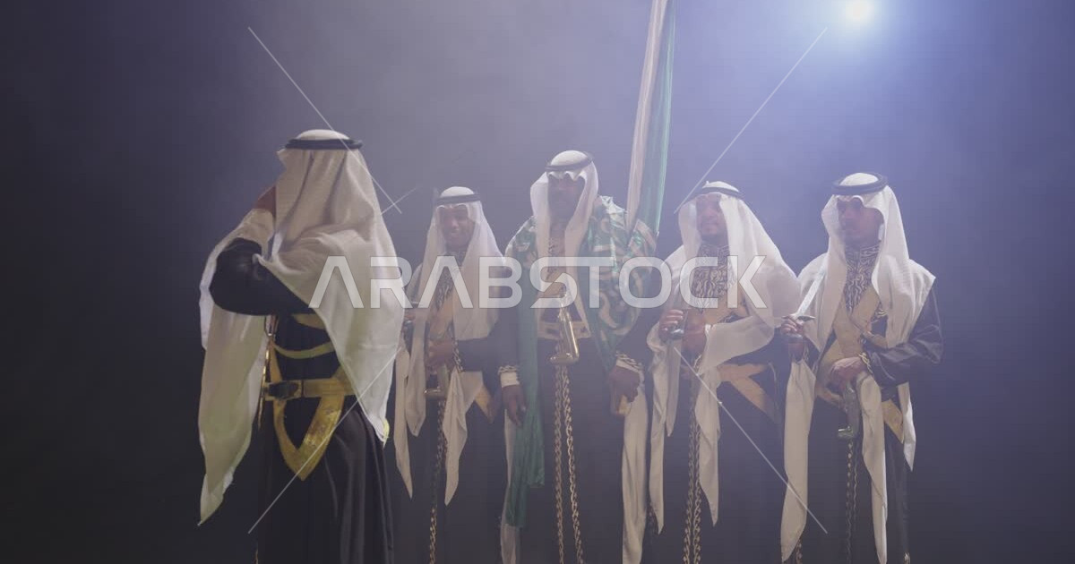 Folk songs and dancing with swords in the Hijazi Ardha, wearing the ...