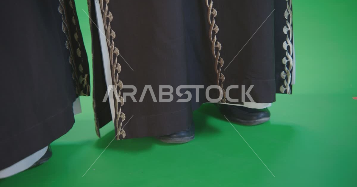 Close-up from right to left of the feet of Saudi Gulf Arab men dancing ...