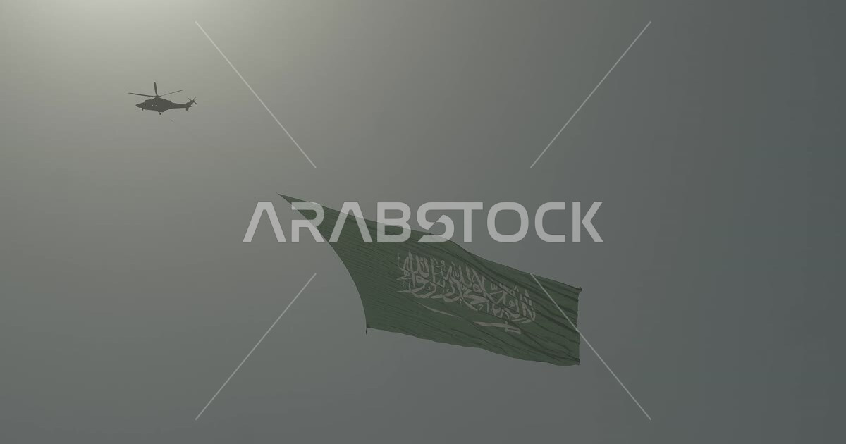 The flag of the Kingdom of Saudi Arabia flutters in the sky in ...