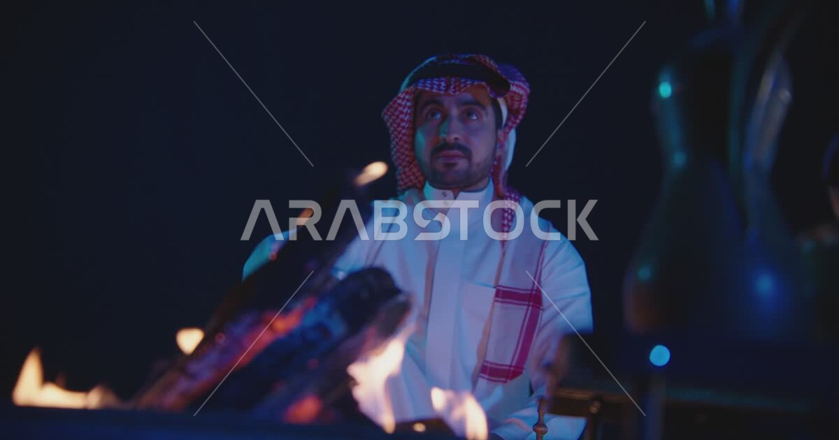 Arabic coffee dallah, two Saudi Gulf Arab men enjoying a night road ...