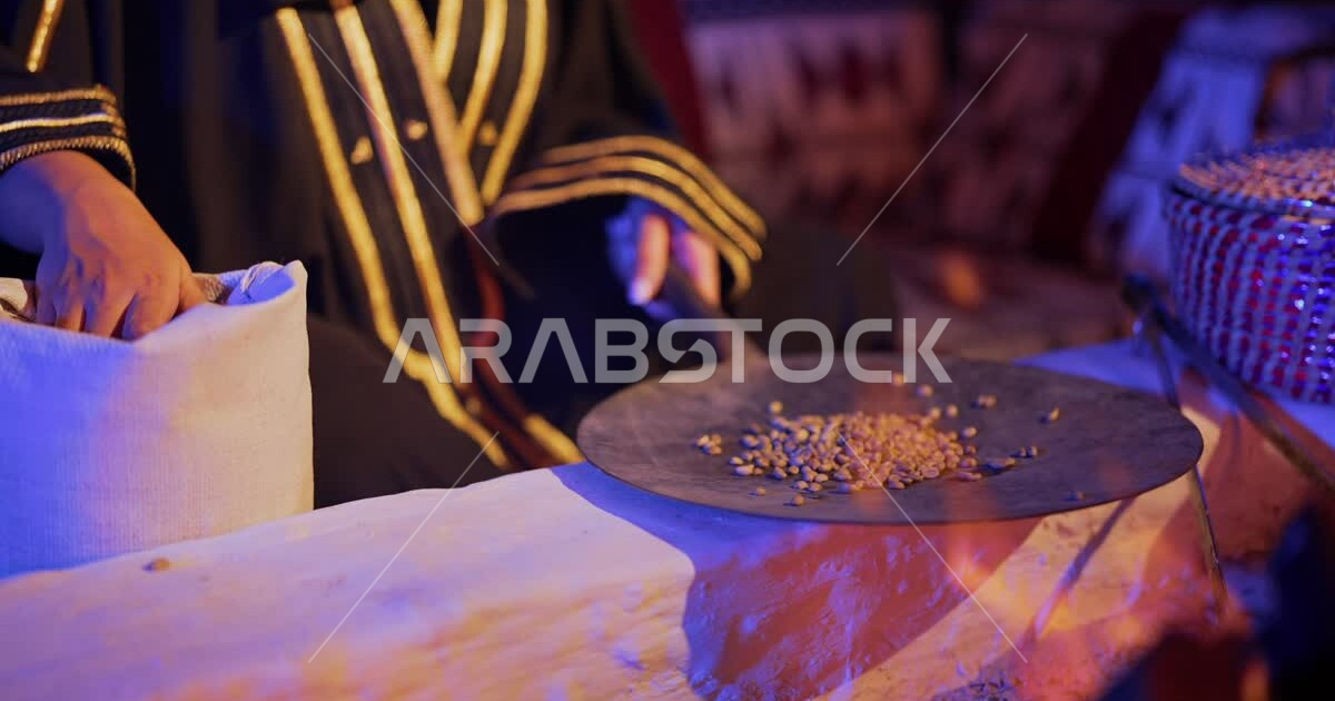 Preparing coffee to prepare traditional Saudi coffee, a close-up of a ...