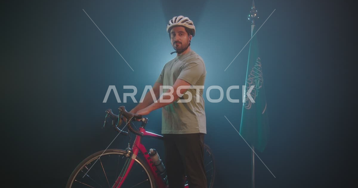 Bicycle riding sport, a Saudi Gulf Arab young man holding a bicycle and ...