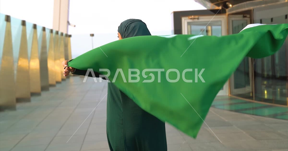 A young Saudi Gulf Arab woman wearing an abaya and hijab, wearing ...