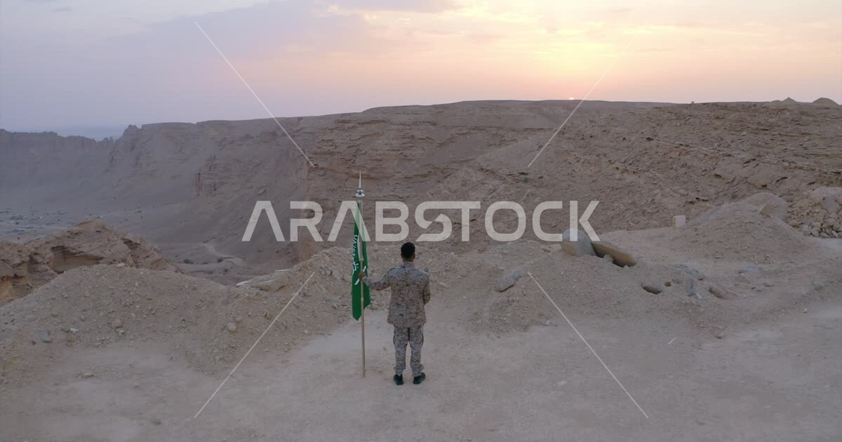 A photograph from the back of a Saudi Gulf Arab soldier carrying the ...