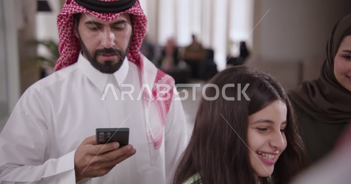 Showing a blank green screen on a mobile phone, a close-up of a Saudi ...