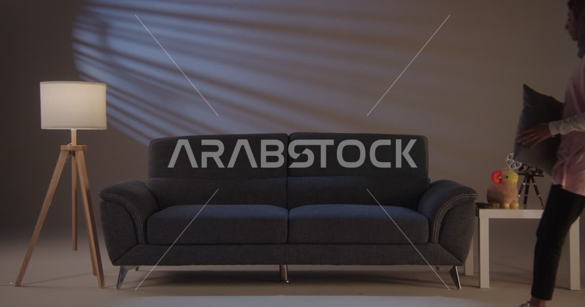 Arranging the room and sitting on the sofa in the living room to enjoy ...