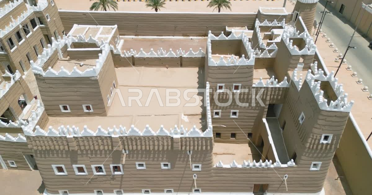 Planting palm trees around ancient buildings in the Aba Al-Saud ...
